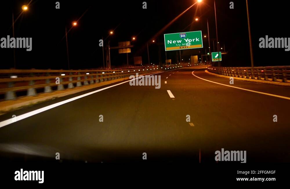 driving on highway/interstate at night, exit sign of the city of new ...