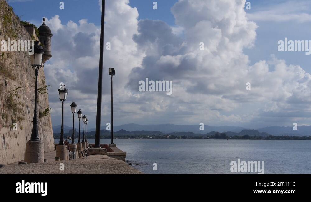 Puerto Rico Paseo la Princesa Bay Walk beneath stone castle walls Old ...