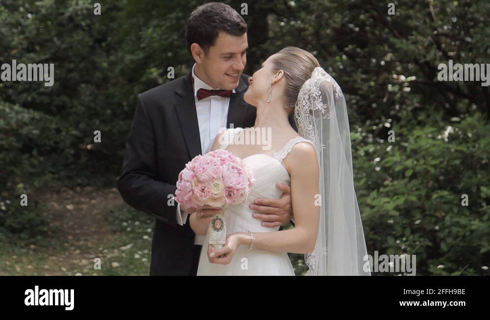 The groom embraces the bride and delicious kisses her with love Stock ...