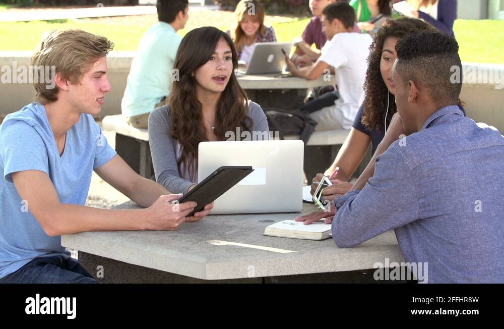 Teacher Helping High School Students Working In Playground Stock Video ...