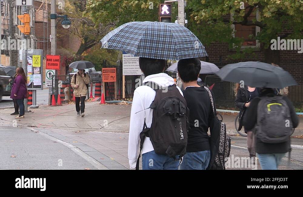 college and university students on campus in wind and rain Stock Video ...