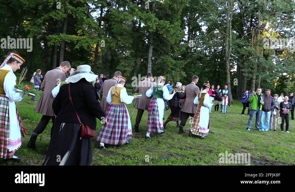 people pairs in national clothes bring burning torch and candles Stock ...