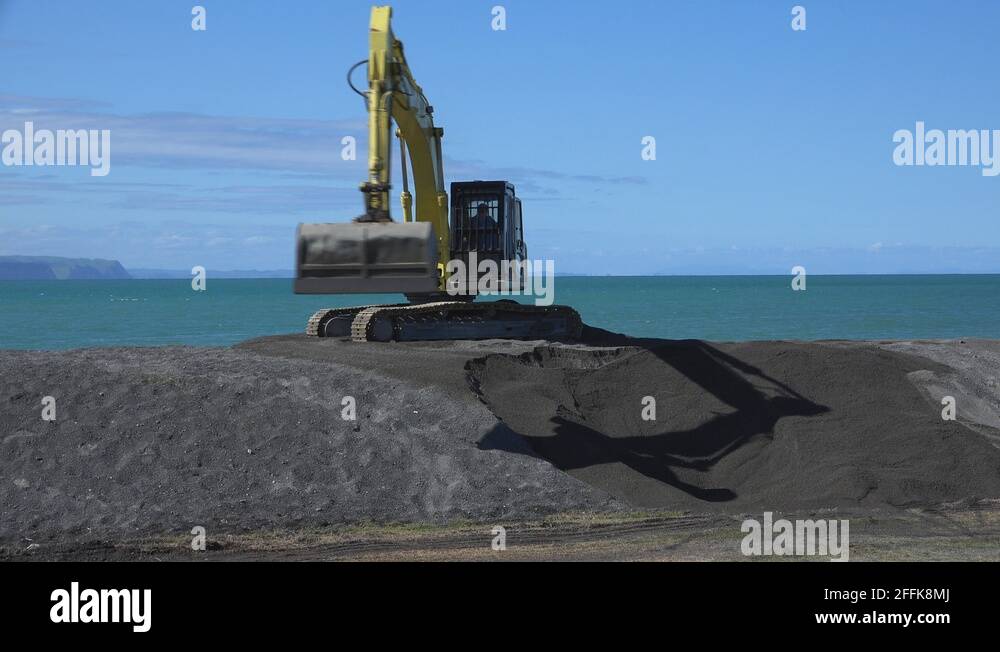 Excavator working on shingle bank seawall HD Stock Video Footage - Alamy