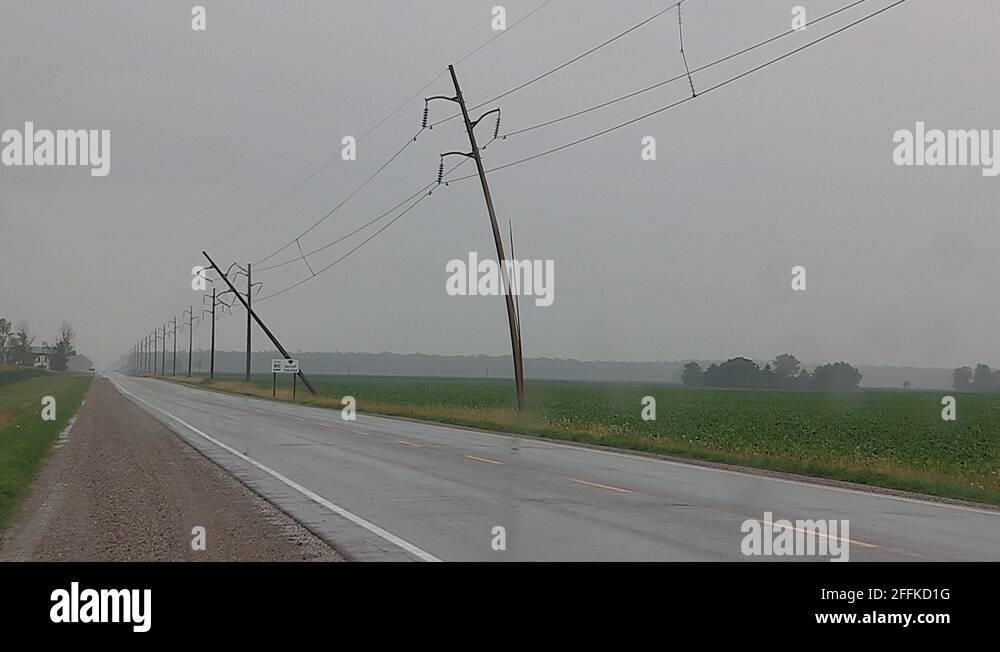 Severe thunder storm and wind damages power lines poles electrical grid ...