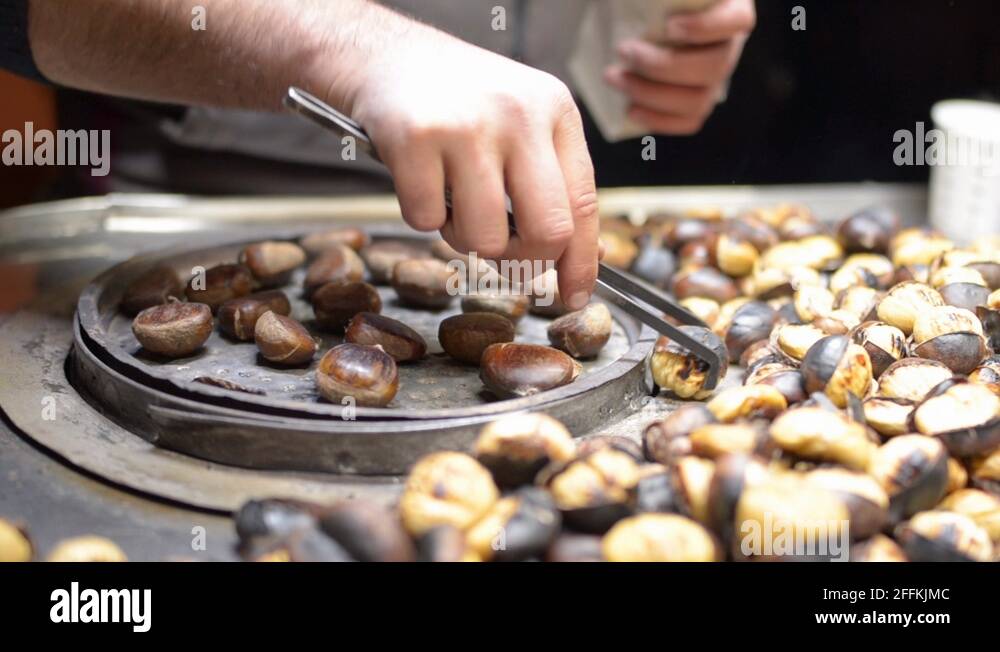 Chestnut roasted cooked street vendor trolley barbecue fast food ...