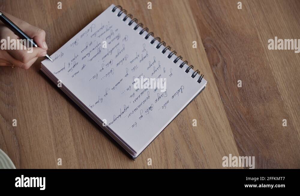Hands drawing in notebook on bege table Stock Video Footage - Alamy