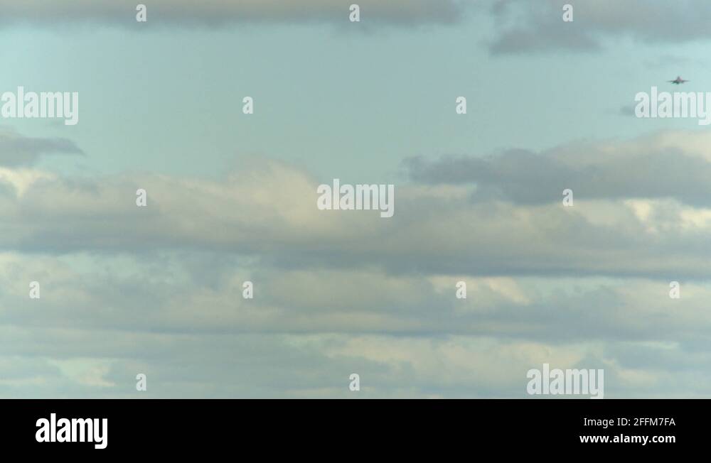 military, F16 Falcon fighter jet through frame, afterburner lit, long ...