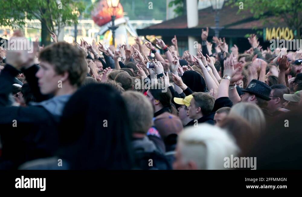 Heavy metal concert crowd gone mad waving hand and clapping after the ...