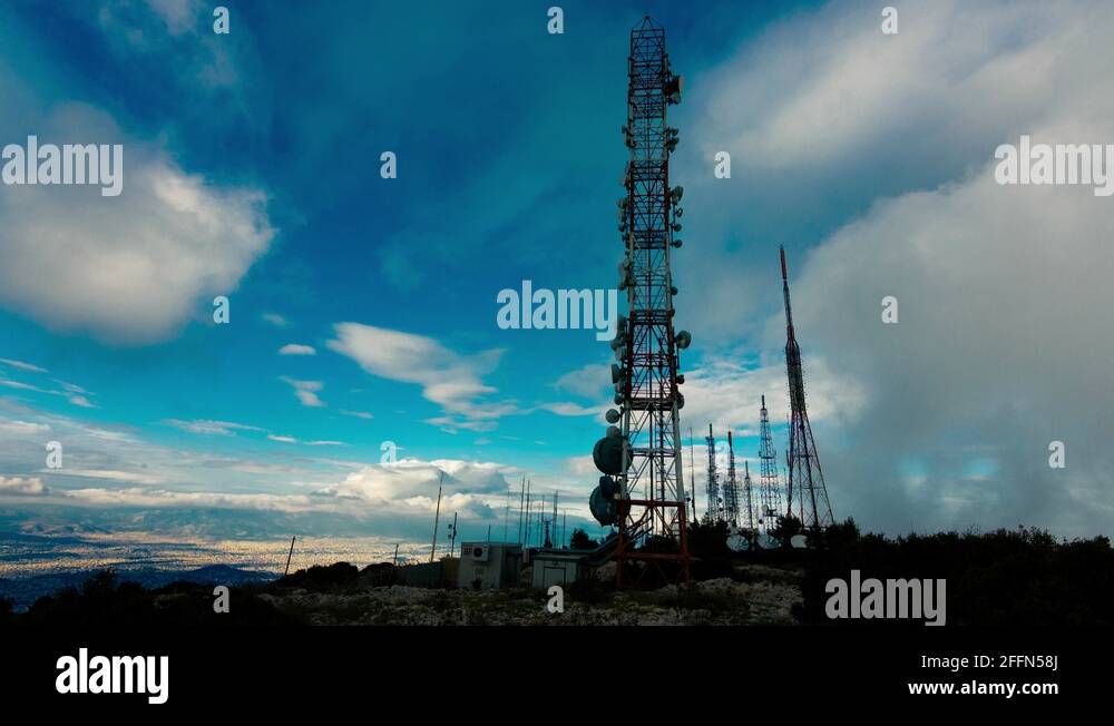 4K big tall communication towers with blue sky and clouds background ...