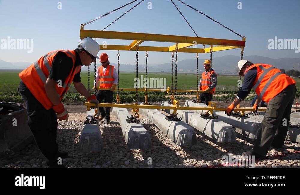 Mechanics install steel reinforced concrete railway sleepers Stock ...