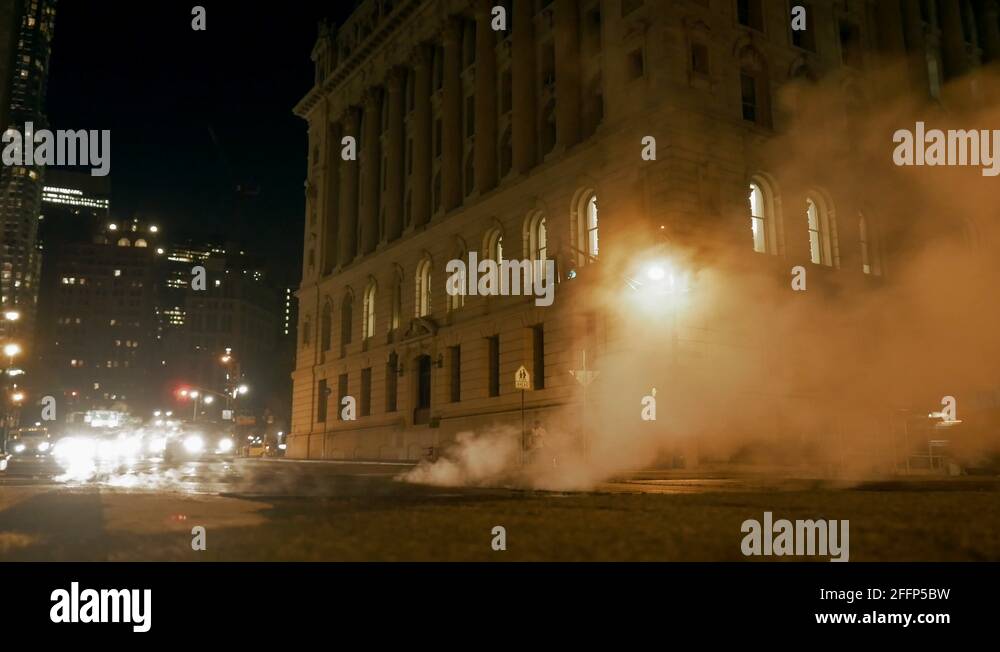 steam over street in new york city at night. traffic lights. urban ...