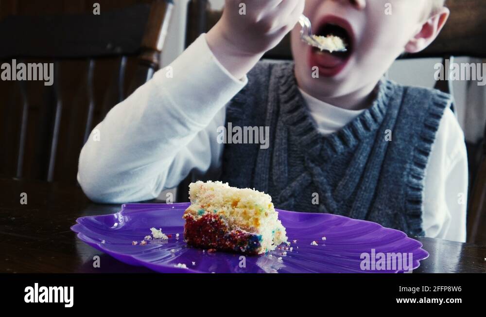 Boy eating birthday cake 4k Stock Video Footage - Alamy