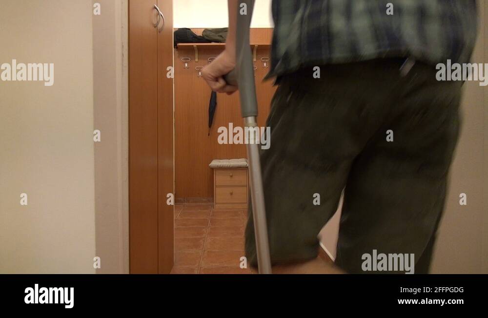 Young man with a plaster cast, limp, broken leg, orthopedic, walking ...