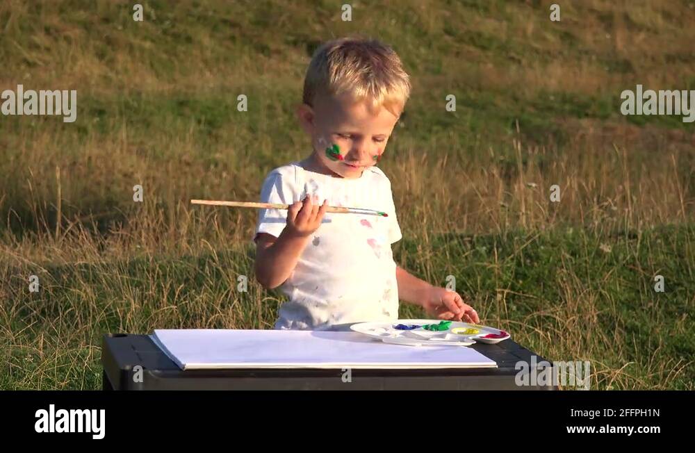 Little boy drawing on his face on nature 4k Stock Video Footage - Alamy