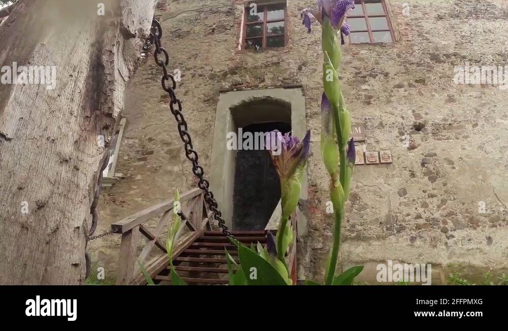 main entrance to the castle fortress. massive wrought iron door, chain ...