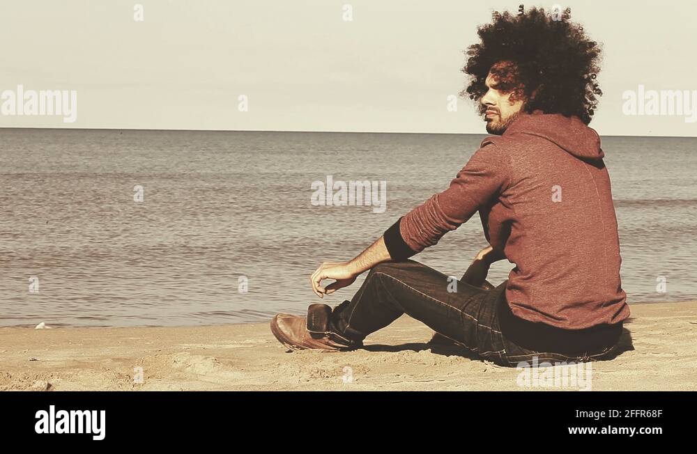 Sad lonely man sitting on the beach thinking Stock Video Footage - Alamy