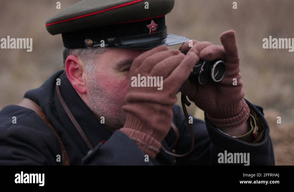 Soviet commander looks through binoculars at the enemy. WW2 ...