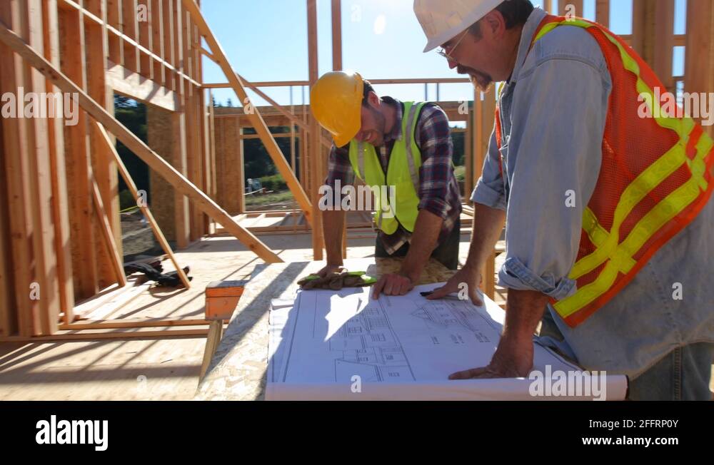 Construction workers looking over plans together Stock Video Footage ...