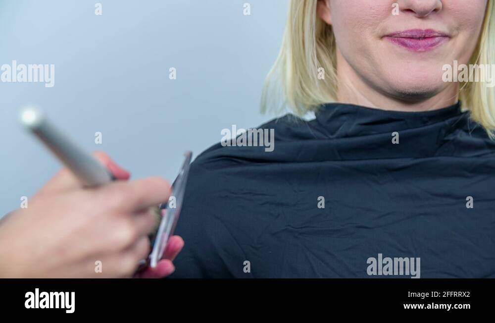 Using the brash to puff the face of a woman Stock Video Footage - Alamy