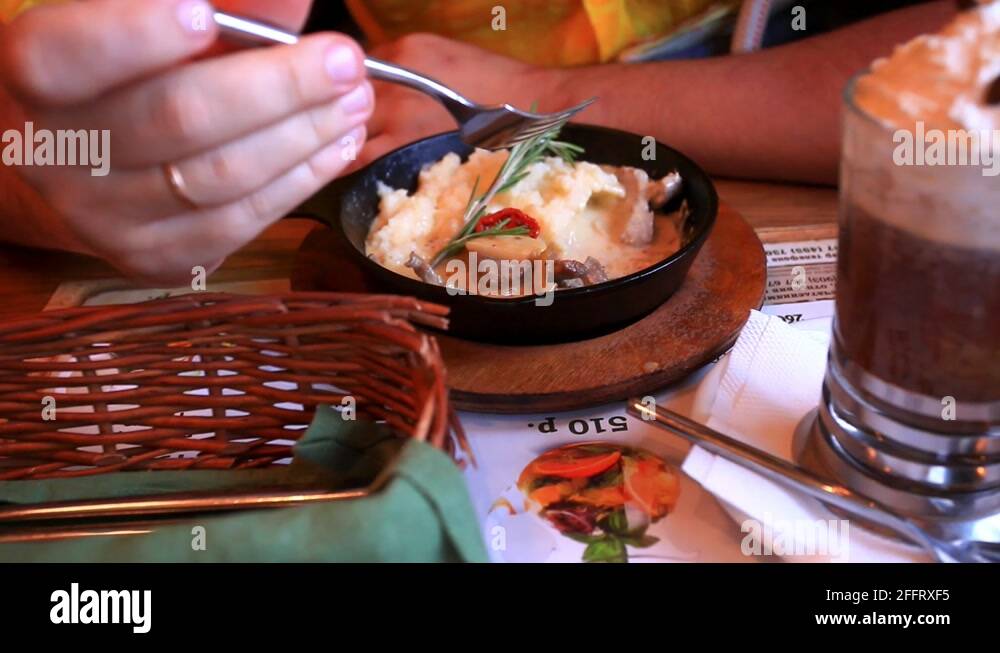 Man eating mash potatoes with meat under the sprig of rosemary. HD ...