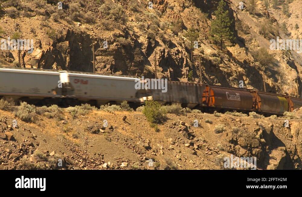 railroad, freight train arid hillside Stock Video Footage - Alamy