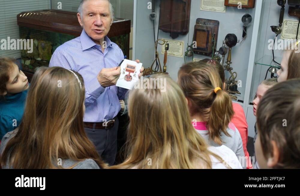 Guide tells for children about exhibits in Museum of phone Stock Video ...