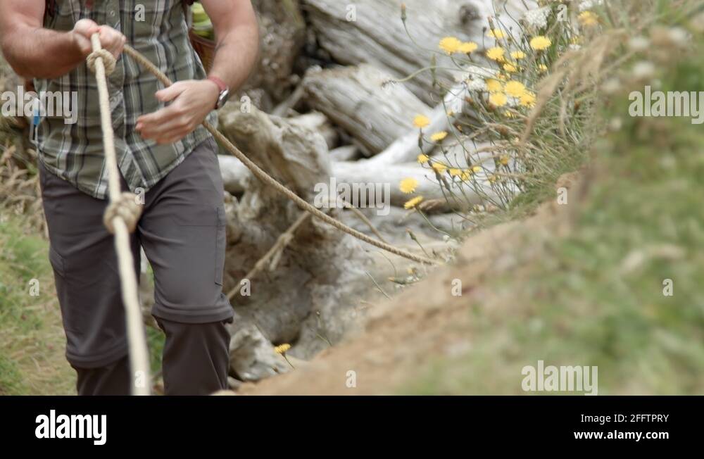 Hiker Uses Rope To Slowly Repel Down Sea Cliff Stock Video Footage - Alamy