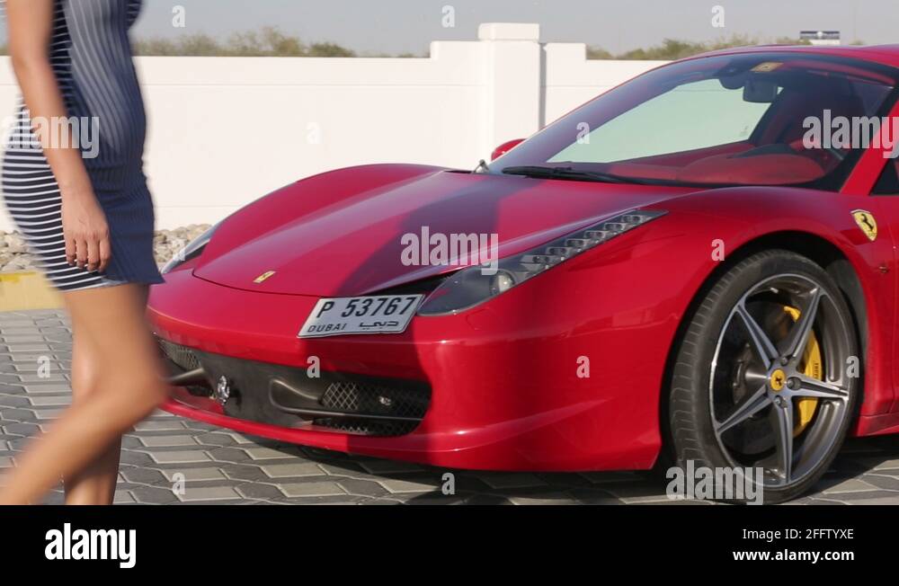 Red Ferrari 458 Spider sports car. Beautiful woman riding a car ferrari ...