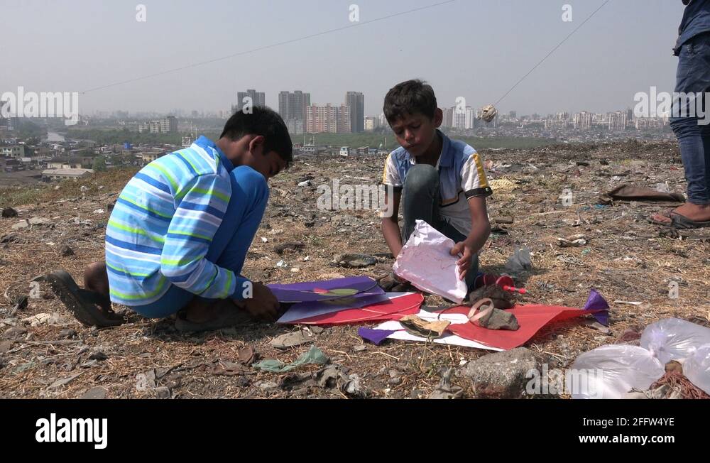 Boys play with kites on garbage dumping ground in Mumbai, India Stock ...