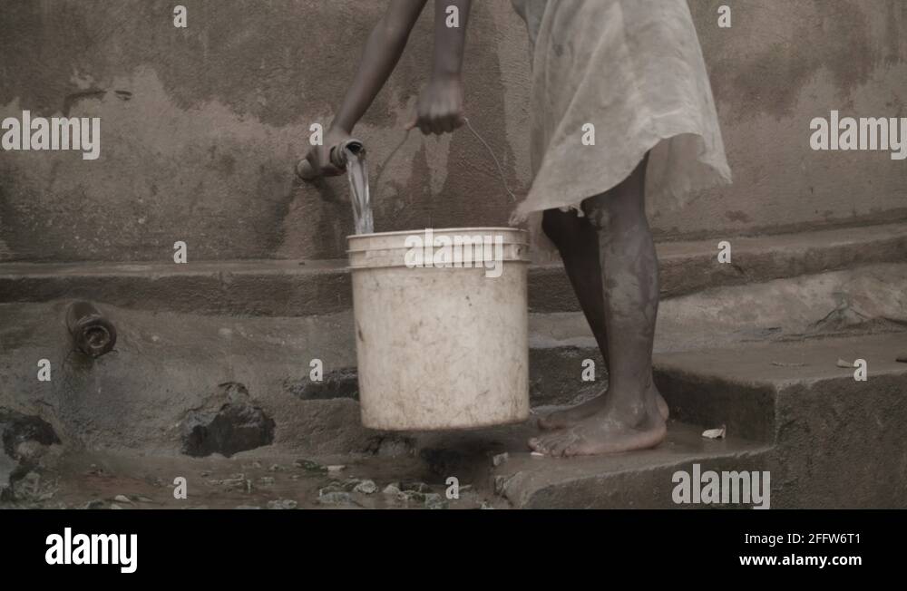 Africa poor African girls fill and carry water bucket pan 2 Stock Video ...