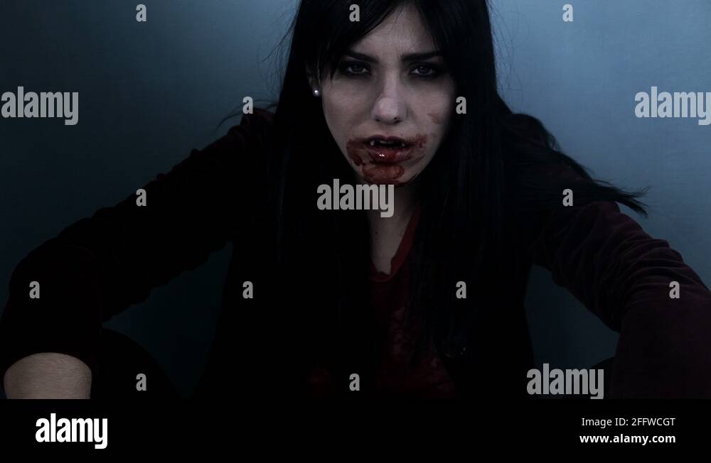 Beautiful female vampire with fog light and blood thinking Stock Video ...