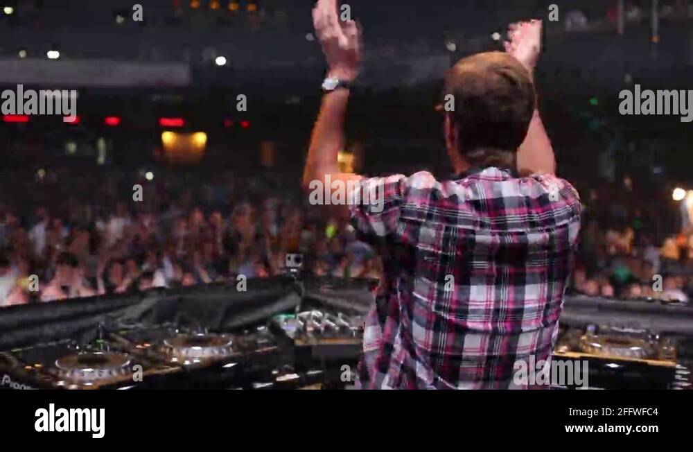 Back of DJ clapping and crowd dance at night club Stock Video Footage ...