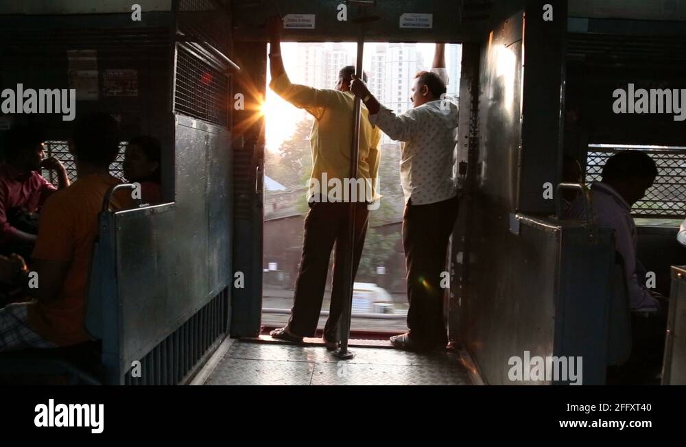 Two Indian men standing at the train entrance during a train ride Stock ...