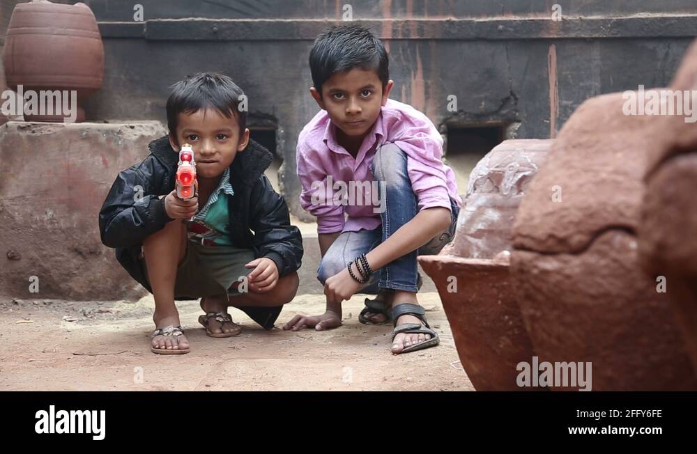 Portrait of two Indian boys pointing a laser gun Stock Video Footage ...