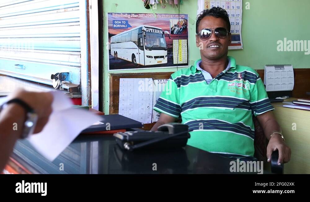 Portrait of Indian man with sunglasses sitting by a counter Stock Video ...
