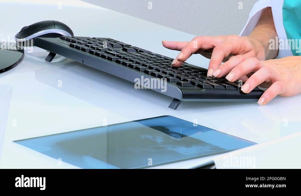 hands Caucasian Western female doctor consultant medical keyboard x-ray ...