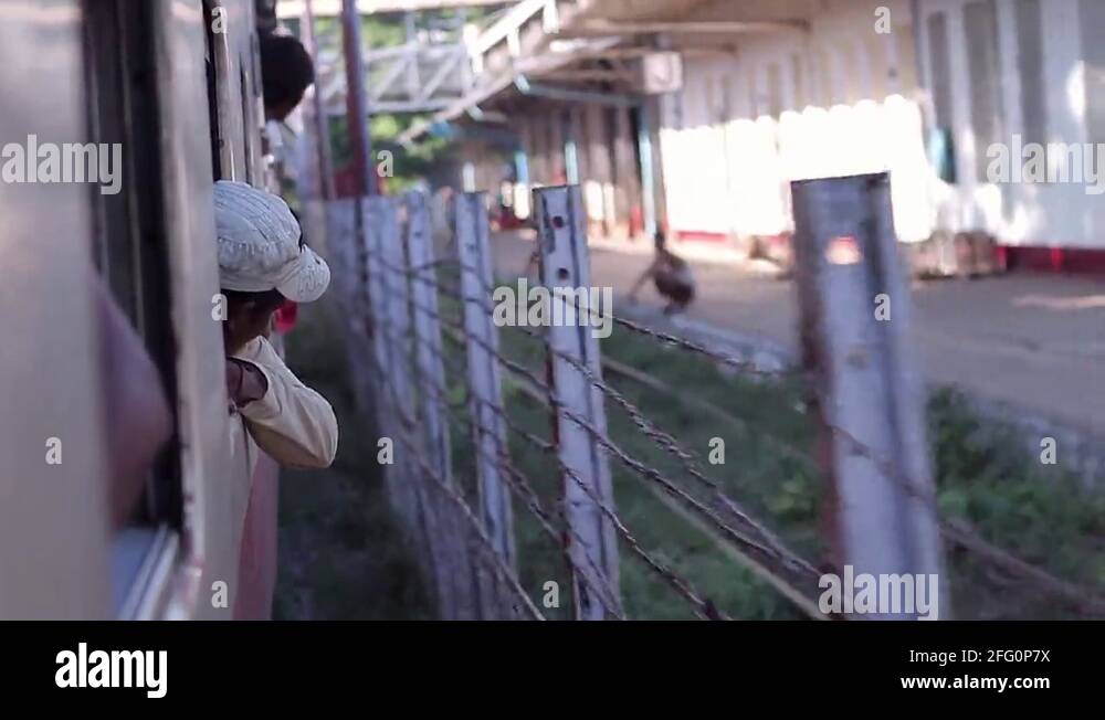 Train travel among poor of India. People look out of the windows Stock ...
