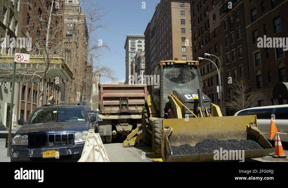 construction vehicle; ho truck; digger tractor on 5th Avenue in 4K ...