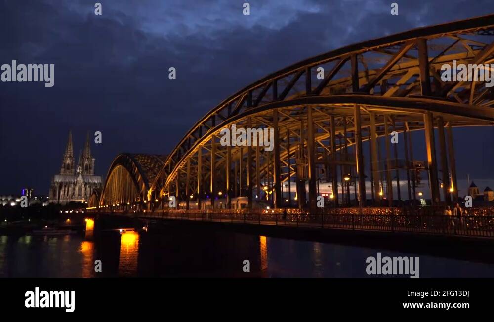 ULTRA HD 4K Traffic train Hohenzollern bridge night church silhouette ...