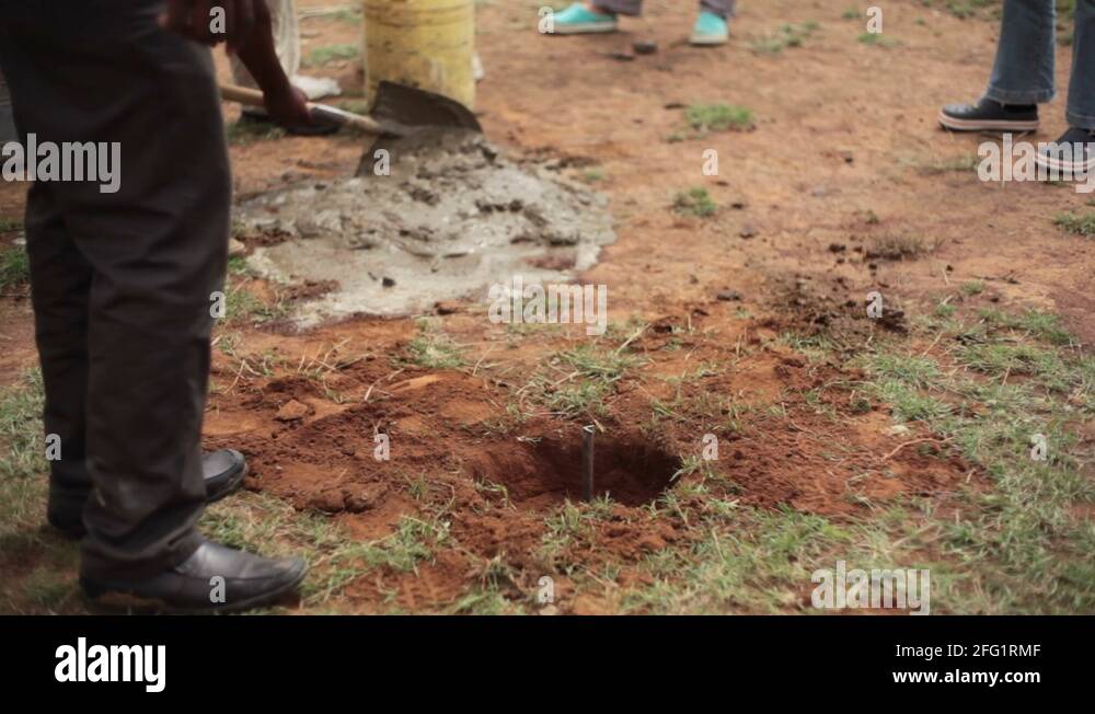 Surveyor making a cement land marker beacon, Africa, Kenya Stock Video ...