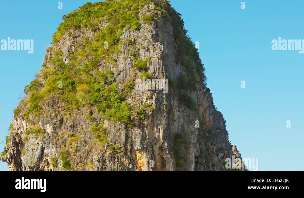 Huge Limestone Rock Towering over a Tropical Beach in Timelapse Stock ...