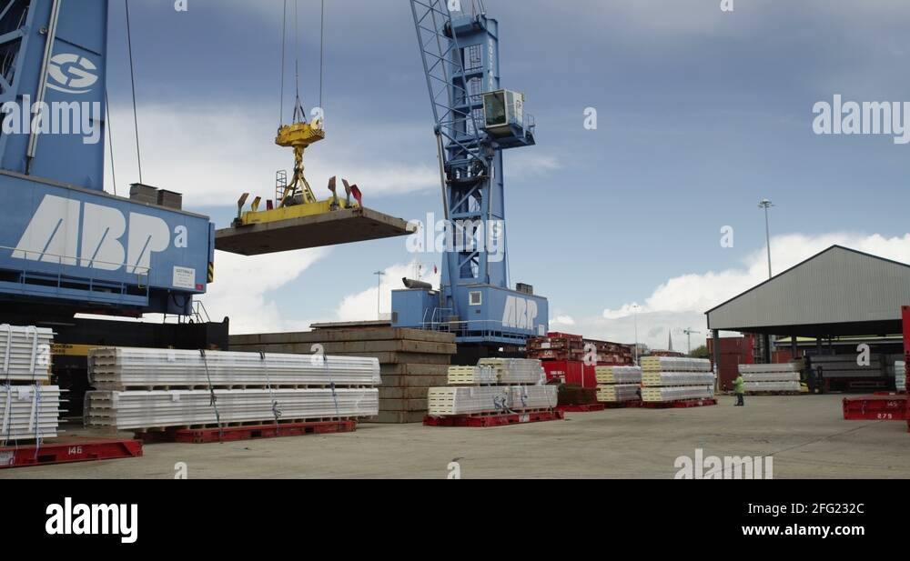 Industrial crane loading and unloading cargo containers at a busy port ...