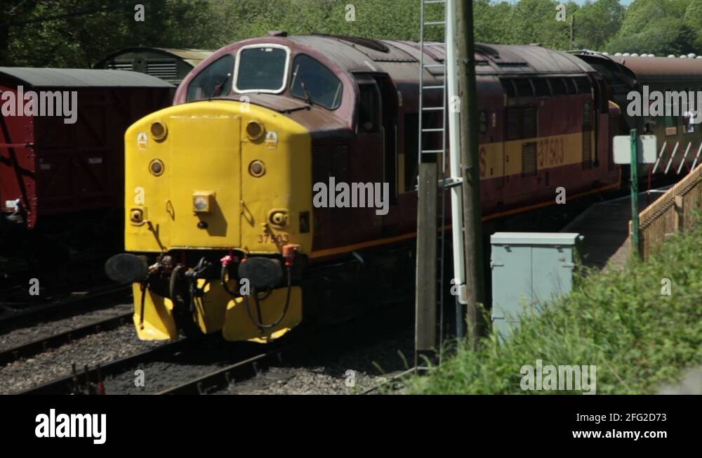 Old English diesel train and carriages leave station 019 Stock Video ...