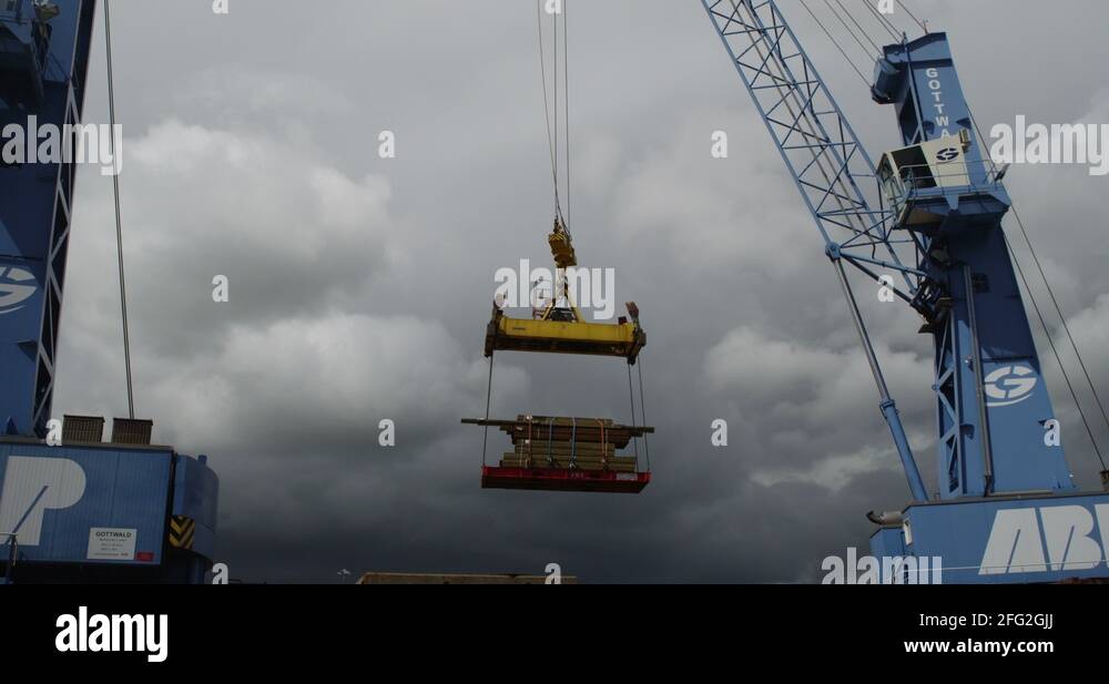 Industrial crane loading and unloading cargo containers at a busy port ...