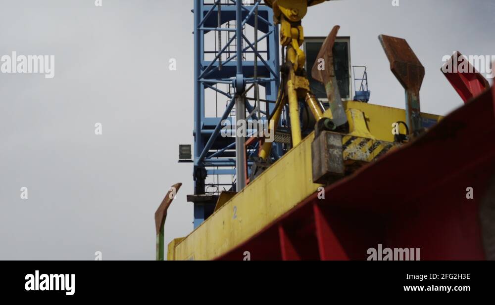 Industrial crane loading and unloading cargo containers at a busy port ...