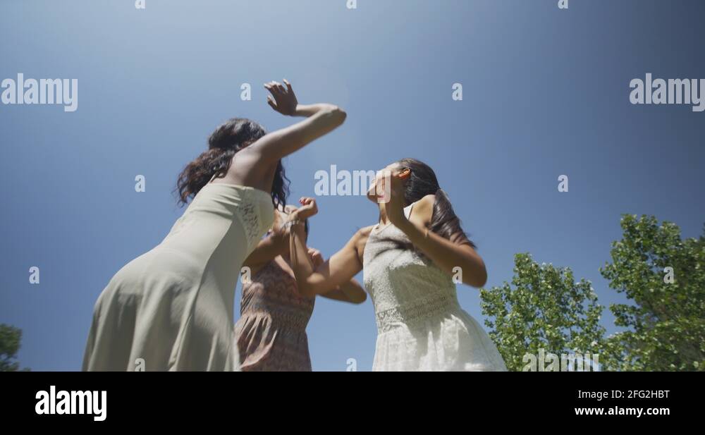 Young women jump to high five Stock Video Footage - Alamy