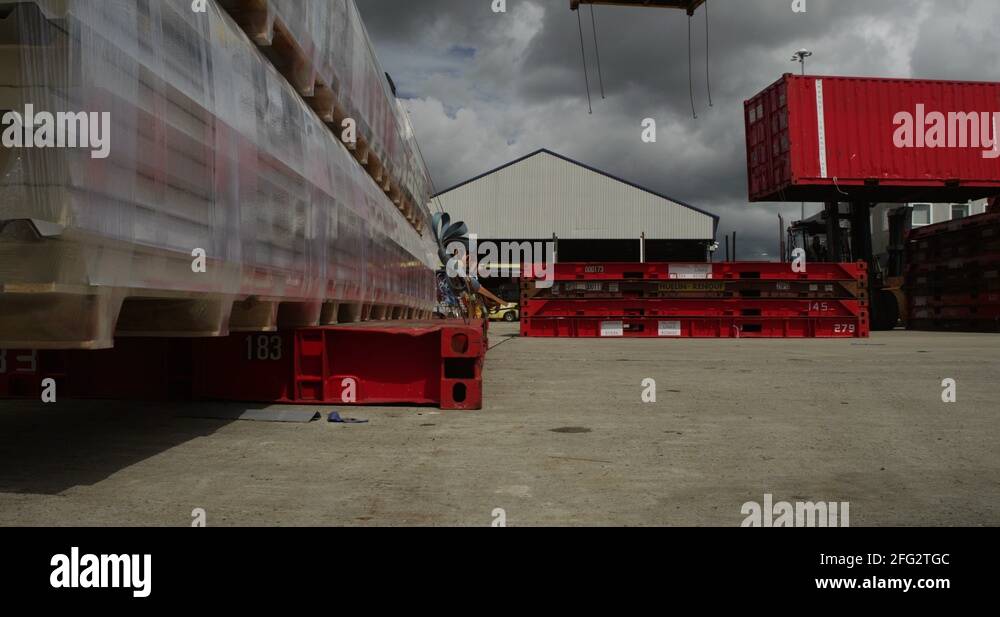 Industrial crane loading and unloading cargo containers at a busy port ...