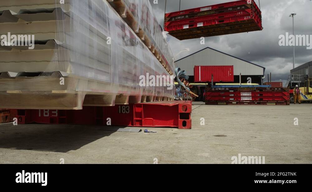 Industrial crane loading and unloading cargo containers at a busy port ...