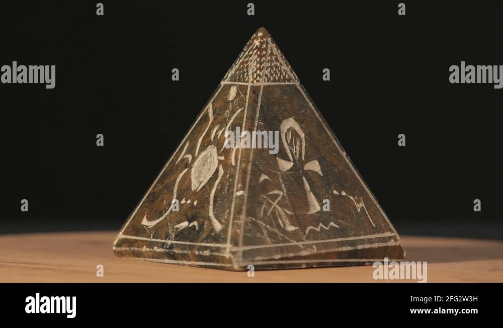 Egyptian Pyramid statue rotating around on a black background Stock ...