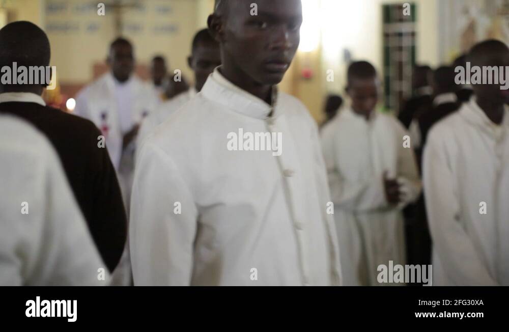 Alter boys and priests walk out of church at the end of mass, Kenya ...